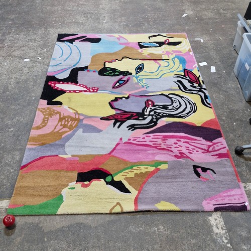 A vibrant modern rug featuring a bold abstract painterly composition ...