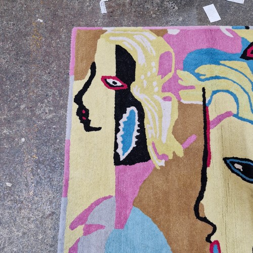 A vibrant modern rug featuring a bold abstract painterly composition ...