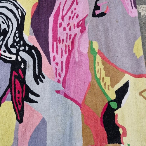 A vibrant modern rug featuring a bold abstract painterly composition ...