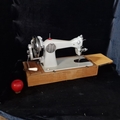 A Novum Mark I sewing machine, in pale grey enamelled metal with ...
