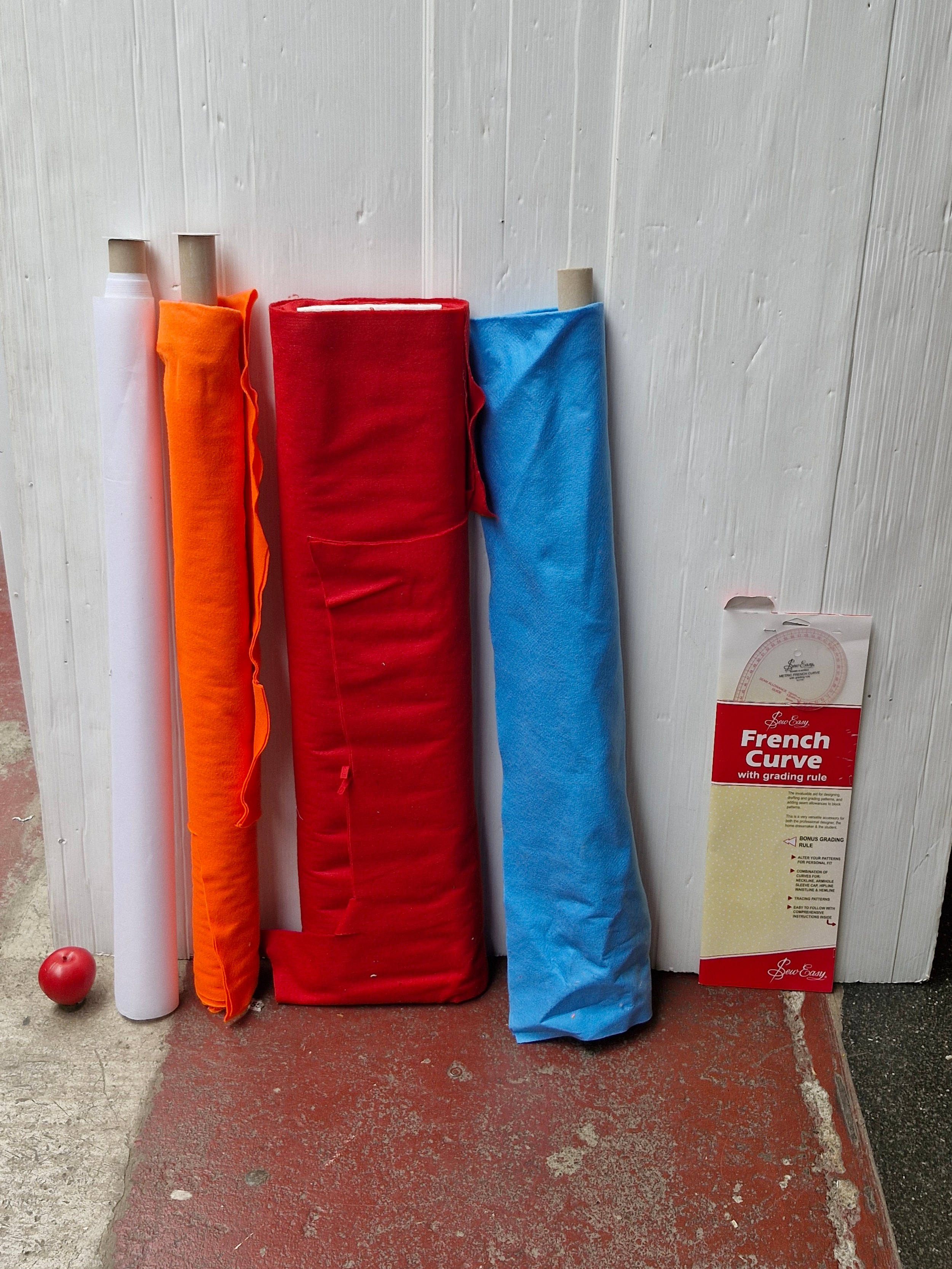 Three large colour bolts of felt in bright vibrant tones of orange ...