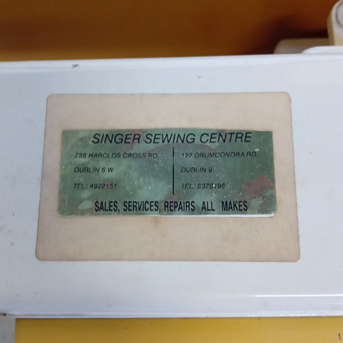 New Home portable sewing machine, of cream and ochre moulded case with ...