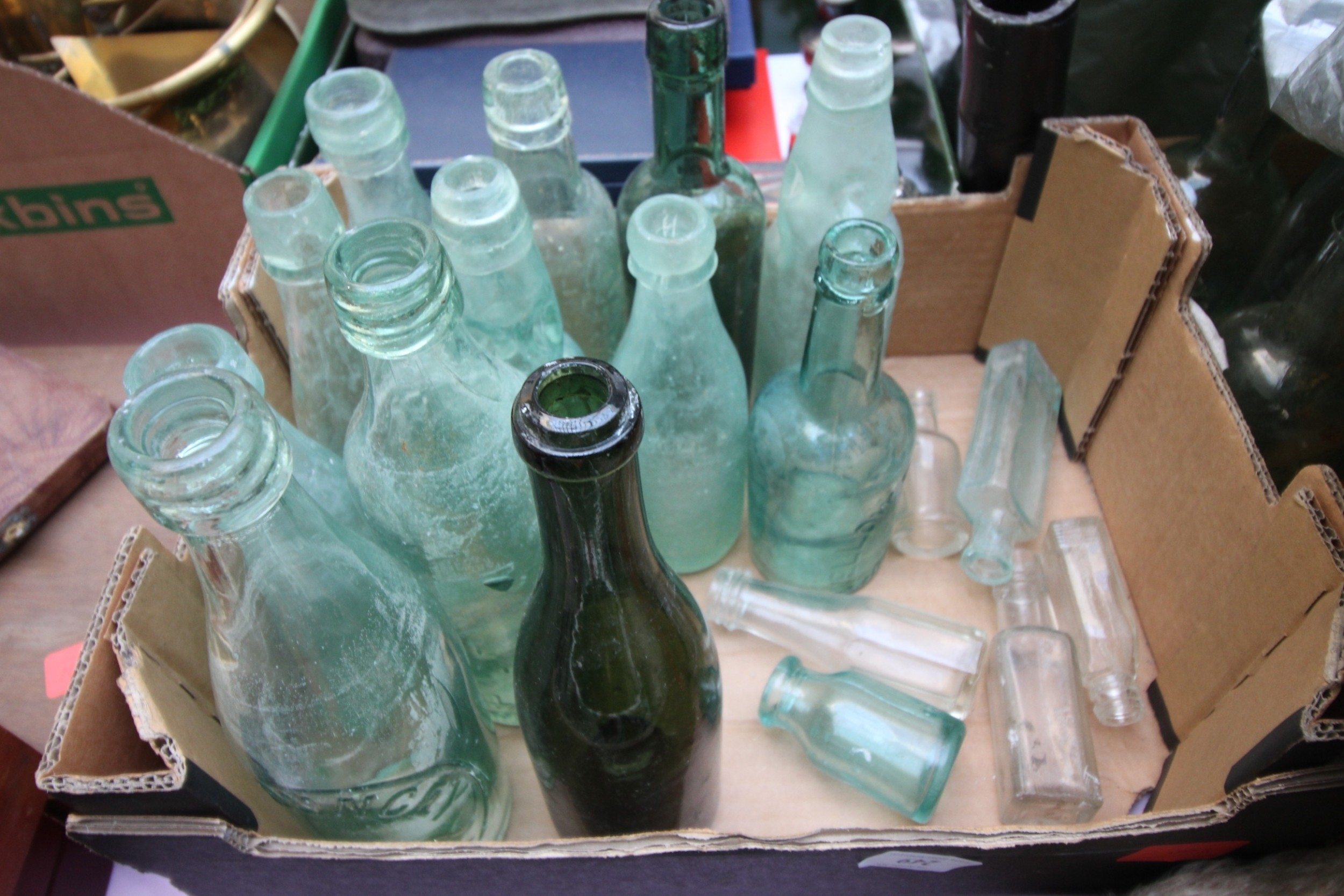 A collection of old glass bottles, various beer bottles and medicine ...