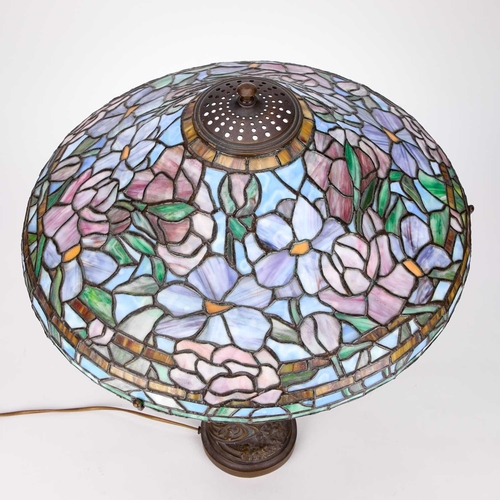 A TIFFANY STYLE BRONZE TABLE LAMP WITH A LEADED AND STAINED GLASS SHADE ...