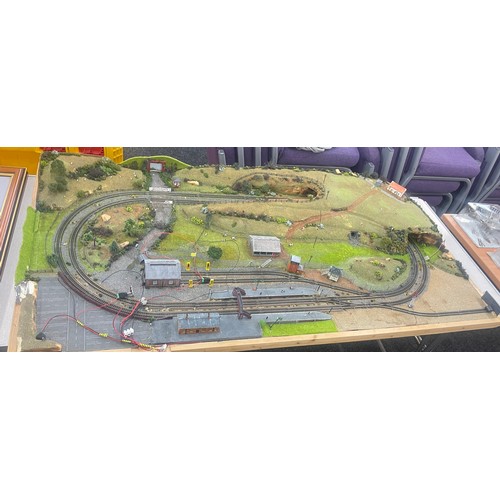 Large train track layout measures approximately 57 inches by 31 inches