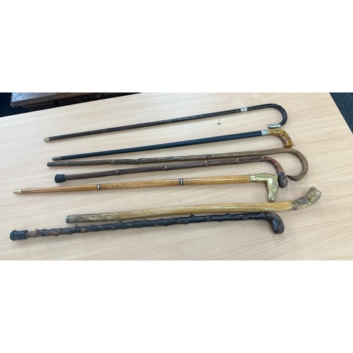 Selection of vintage walking sticks to include two silver rimmed etc