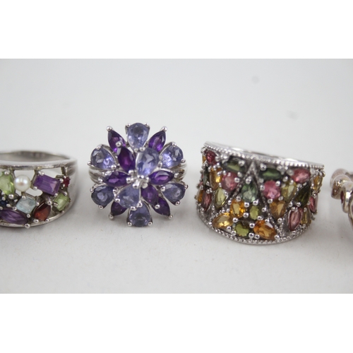 A collection of silver stone set rings including tanzanite and ruby