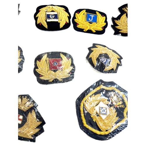 10 Different hand embroidered gold wire merchant navy officers cap badges