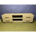 A contemporary industrial style long low cabinet with 4 drawers and ...