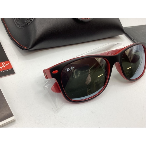 A pair of Ray-Ban Ferrari sunglasses in black and red stitched case ...