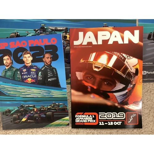 A collection of Formula 1 posters and memorabilia. Paddock passes ...