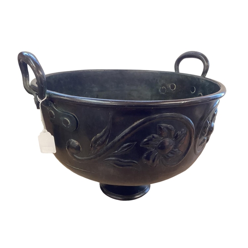 A large bronze and embossed two handled bowl, on raised circular plinth ...