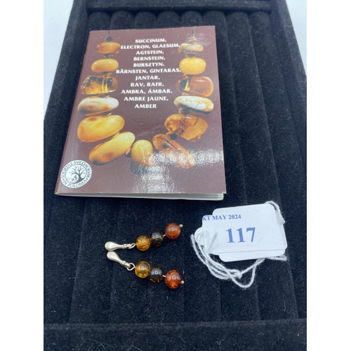 A pair of amber drop ear rings.