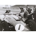 Three framed and glazed photographs , Stirling Moss in a Jaguar C Type ...
