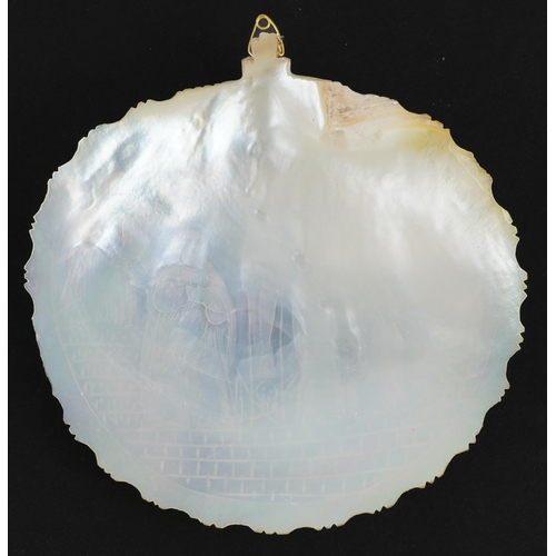 Mother of pearl shell carved with Christ on the cross, 12cm wide