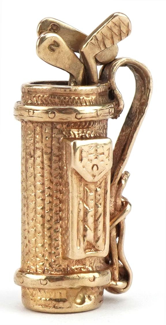 Unmarked gold golf club and caddy charm, tests as 9ct gold, 2.5cm high ...