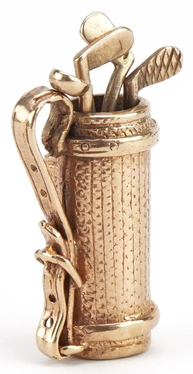Unmarked gold golf club and caddy charm, tests as 9ct gold, 2.5cm high ...