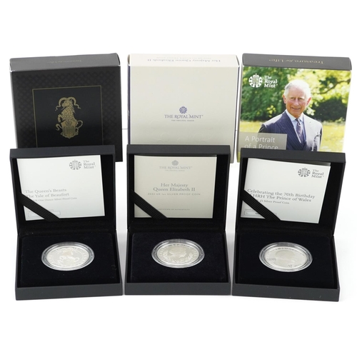 Three silver proof coins by The Royal Mint with cases and boxes ...