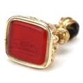 A Victorian yellow metal carnelian seal fob, the matrix engraved with a ...