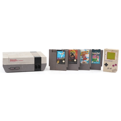 A vintage Nintendo Entertainment games system with four games and ...