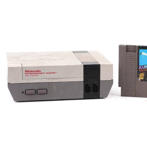 A vintage Nintendo Entertainment games system with four games and ...