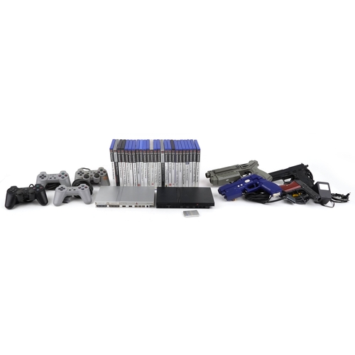 Two Sony PlayStation 2 games consoles with four controllers , four guns ...