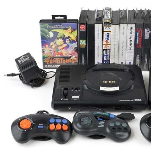 Vintage Sega games consoles with controllers and a selection of games ...