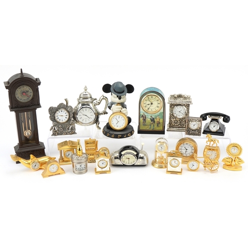 A collection of miniature decorative clocks in various forms, the ...