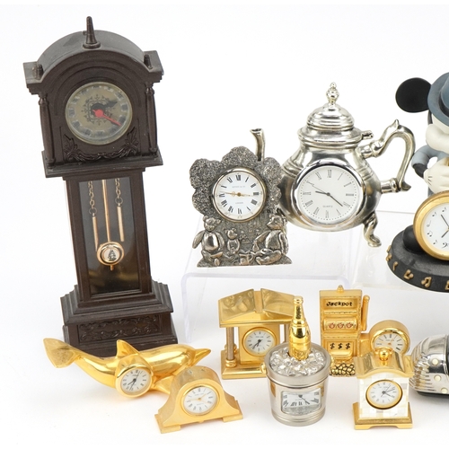 A collection of miniature decorative clocks in various forms, the ...