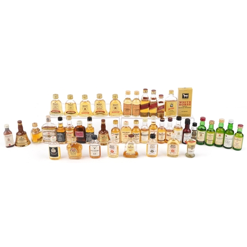 A collection of whisky alcohol miniatures including White Horse ...
