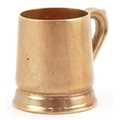 A 9ct gold charm in the form of a tankard, 1.3cm high, 1.9g.