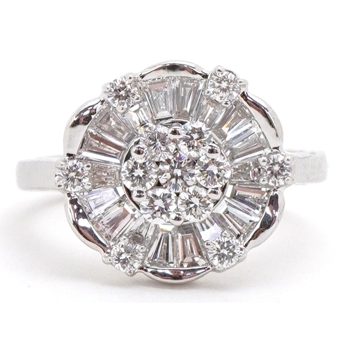 An 18ct white gold flower head ring set with baguette cut and round ...