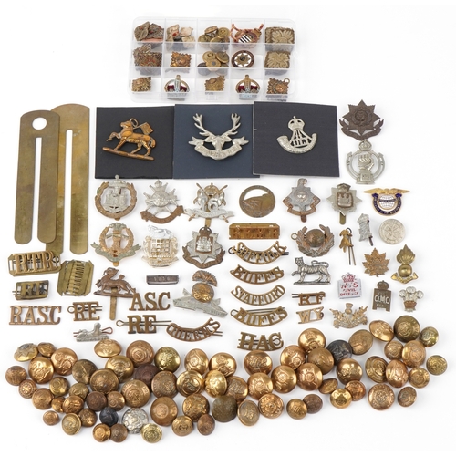 A collection of military interest cap badges and uniform buttons ...