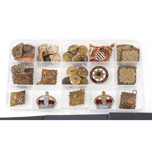 A collection of military interest cap badges and uniform buttons ...