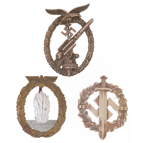 Three German military interest cap badges.