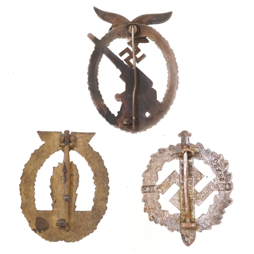 Three German military interest cap badges.