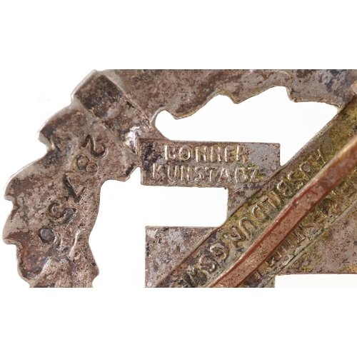 Three German military interest cap badges.