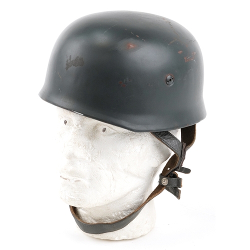 A military interest tin helmet with liner.