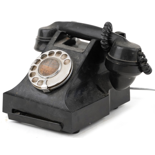 A vintage black Bakelite dial telephone, the handset numbered 164 64.