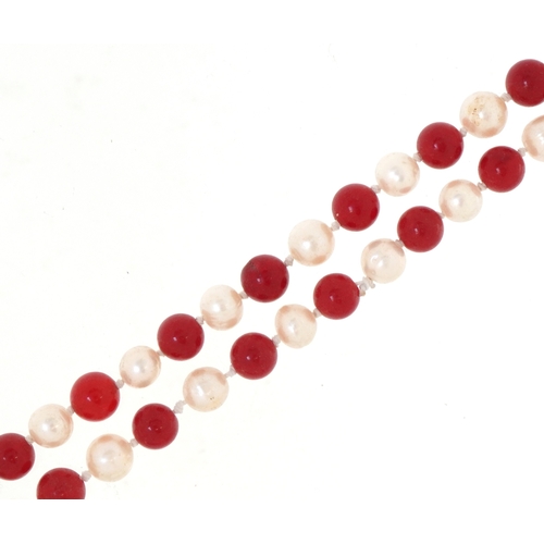 A Chinese red stone and freshwater pearl necklace, each bead 8.5mm in ...