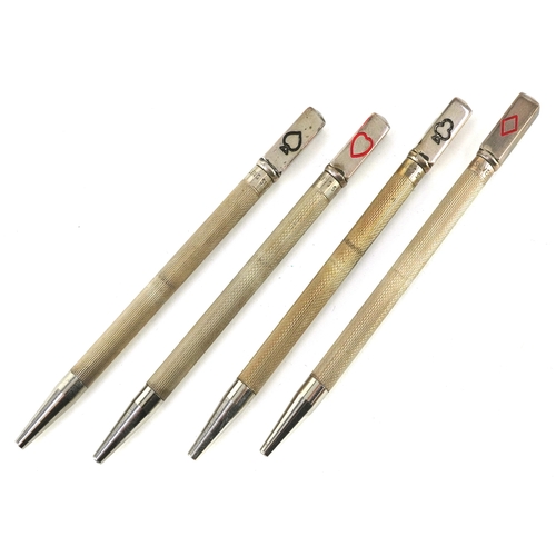 A set of four sterling silver and enamel propelling bridge pencils ...