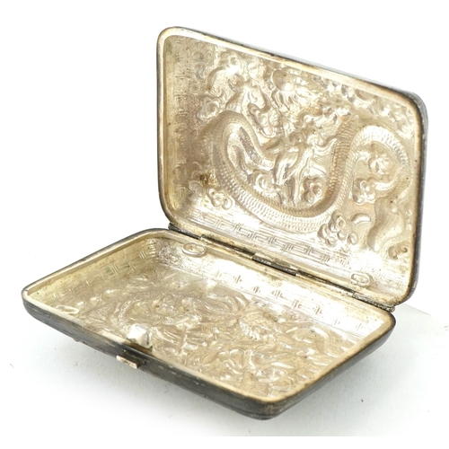 A Chinese export unmarked silver cigarette case profusely embossed with ...