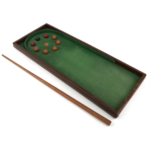 An early 20th century table top billiards game with cue and eight balls ...