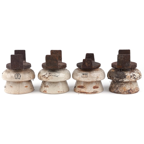 A group of four mid 20th century ceramic and cast iron railway ...