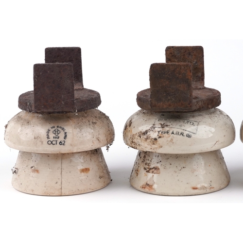 A group of four mid 20th century ceramic and cast iron railway ...