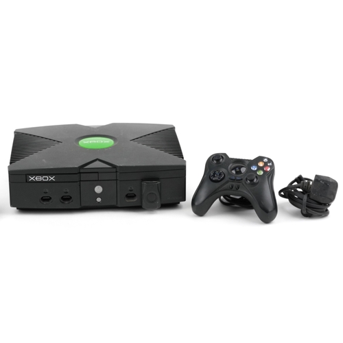 The Xbox games console with two controllers and a remote control.