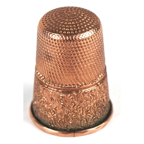 An unmarked gold thimble with engraved decoration, 2.3cm high, 5.2g.