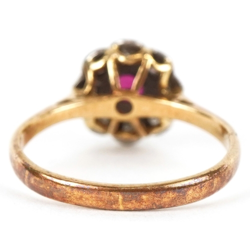 An 18ct gold ruby and diamond flower head ring, size K, 2.5g.