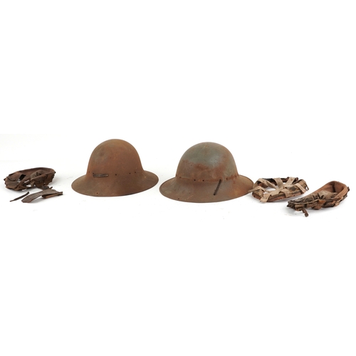 Two military interest tin helmets.