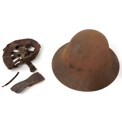 Two military interest tin helmets.